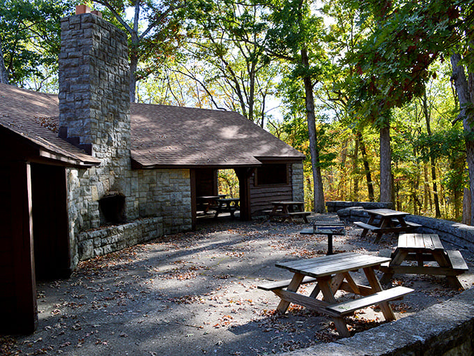 The Oak Grove Shelter's sturdy fireplace has warmed generations of visitors, while autumn trees provide nature's decoration.