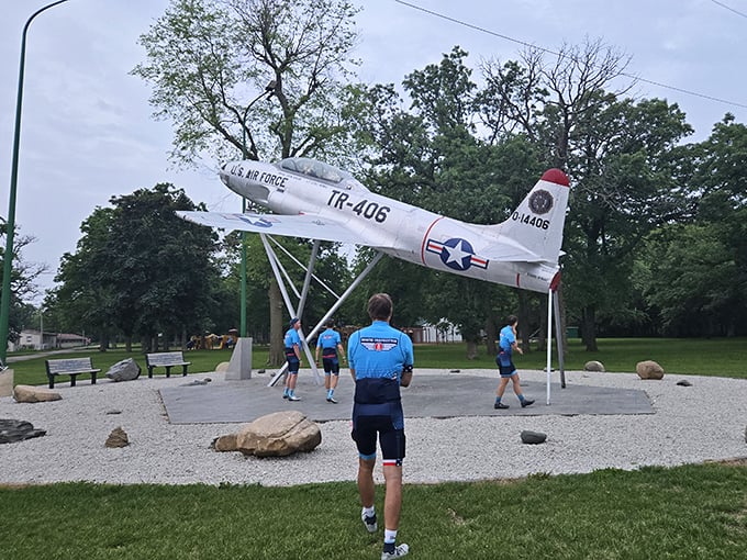 City Park's vintage aircraft display offers a surprising touch of history amid green space, where children play and seniors reminisce under Iowa's vast sky. 