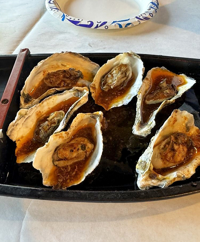 These oysters aren't just served; they're presented&mdash;each one a briny jewel enhanced by a touch of sauce that complements without overwhelming.