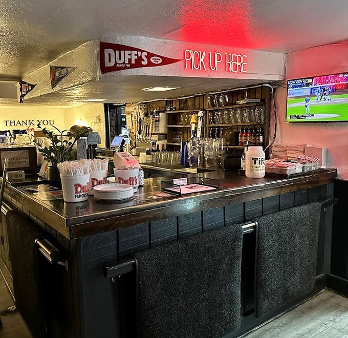 The pickup counter where wing dreams come true. That "PICK UP HERE" sign might as well read "HAPPINESS DISTRIBUTED HERE."