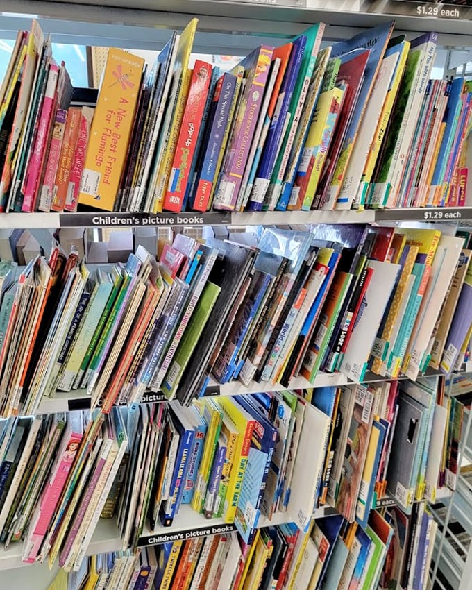 Picture books stacked like colorful dominoes, each one a portal to adventure for little Alaskans with big imaginations.