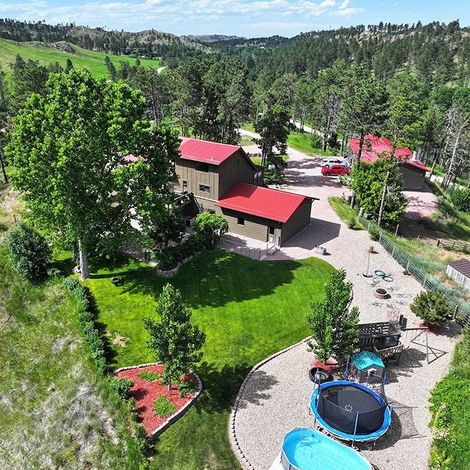 Cabins nestled among pines with a trampoline in the yard? This Pine Ridge retreat is where "getting away" meets "having it all."