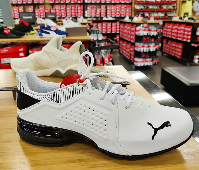 White Puma sneakers sit like pristine sculptures, whispering promises of athletic prowess or, at minimum, stylish grocery store runs.