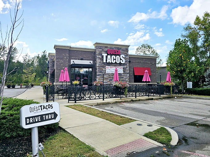 Quesa Tacos' vibrant patio umbrellas signal a fiesta waiting to happen, with drive-thru convenience for taco emergencies.