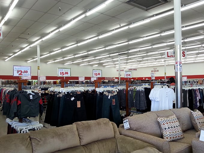 Racks of clothing under fluorescent lights tell stories of workdays, special occasions, and fashion trends come full circle.