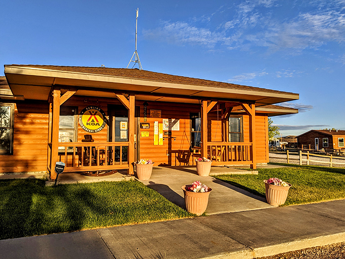 Rawlins KOA Journey welcomes road-weary travelers with that golden-hour glow that makes even a simple cabin look like a five-star accommodation.