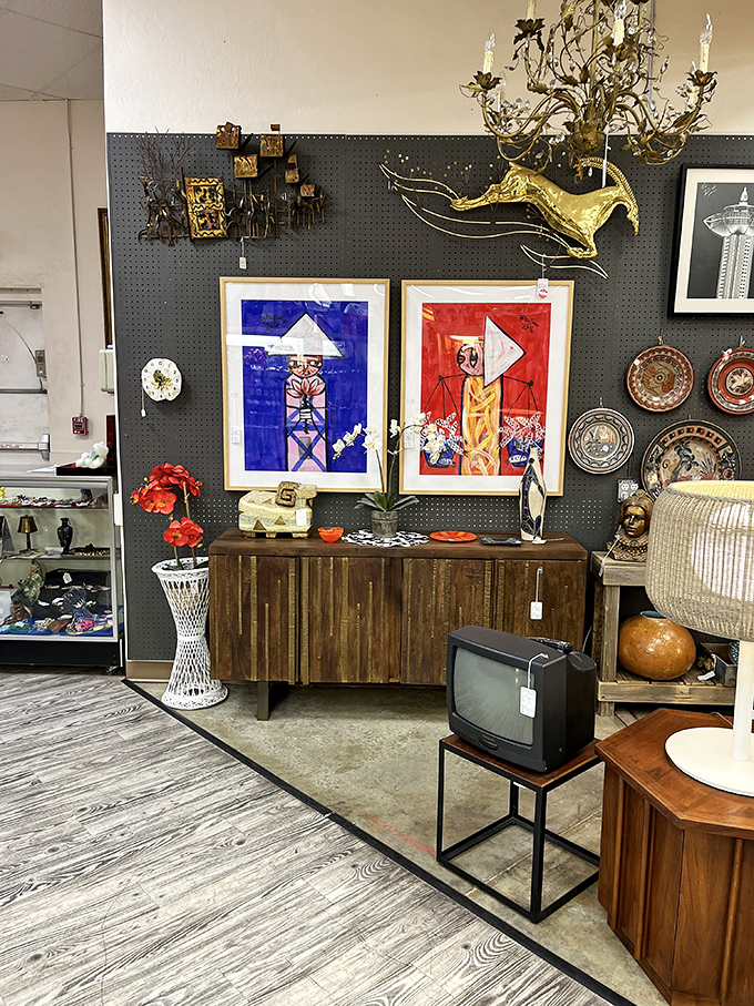 Mid-century art meets vintage electronics in this perfectly curated corner. That TV probably broadcast the moon landing to an awestruck family.