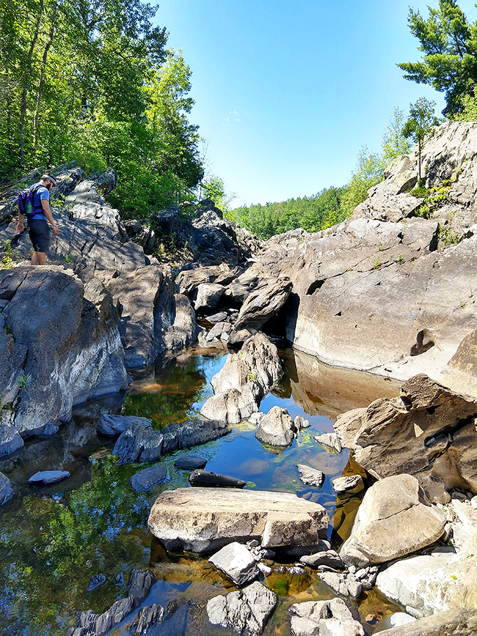 Nature's playground: ancient rock formations create pools and passages where explorers can discover the river's secrets up close.