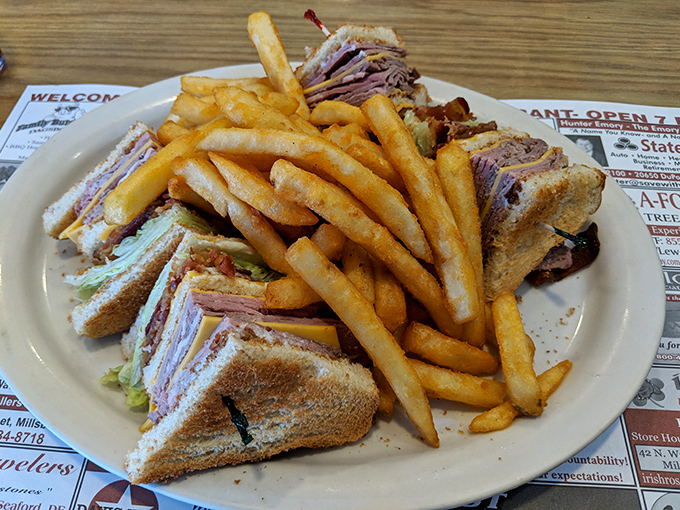The club sandwich&mdash;mankind's greatest architectural achievement involving bread, meat, and toothpicks&mdash;stands tall alongside golden fries that demand respect.