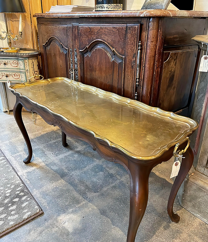 This tray table isn't just furniture&mdash;it's jewelry for your living room. That brass surface practically begs for a cocktail and witty conversation.