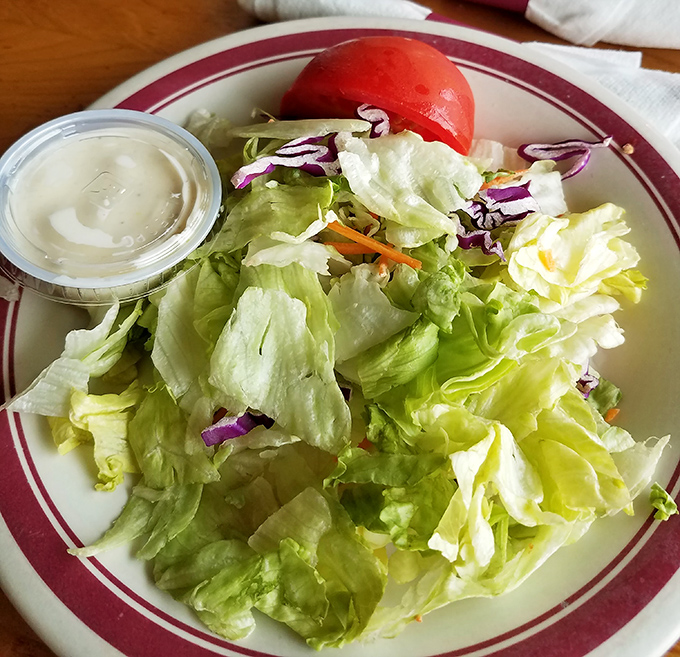 A simple house salad that knows its role&mdash;bringing fresh crunch and color to the table before the main event arrives.