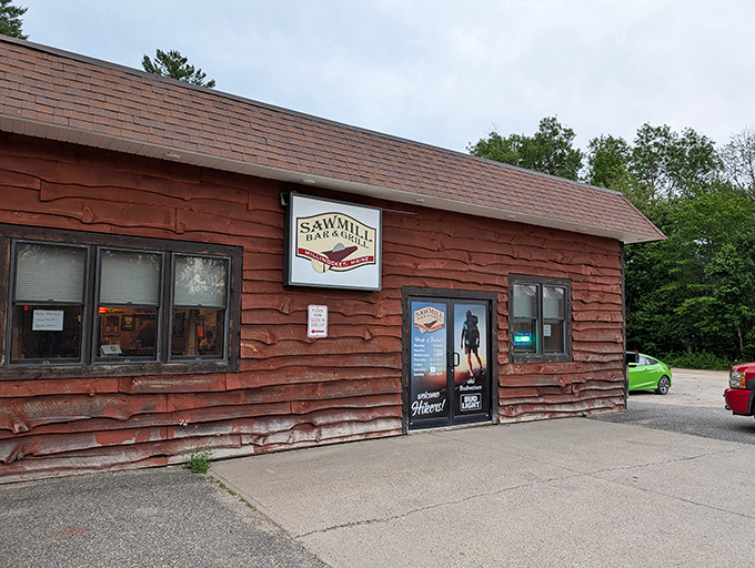 The Sawmill Bar & Grill wears its industrial heritage proudly. Those weathered red boards have witnessed decades of after-work stories and weekend celebrations.