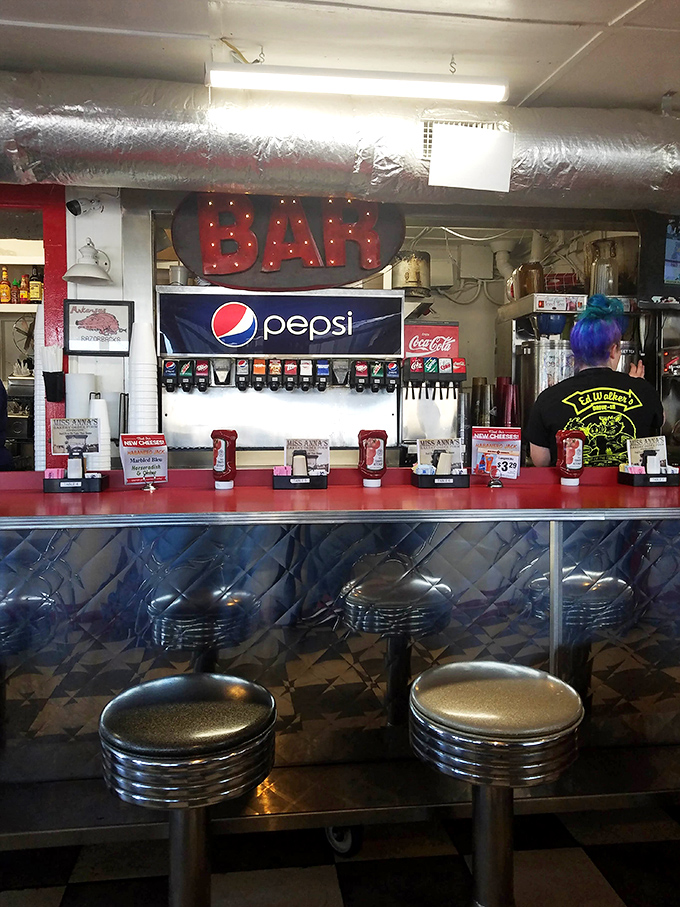 Chrome stools lined up at the counter like soldiers, ready for the next wave of hungry patrons seeking diner perfection.