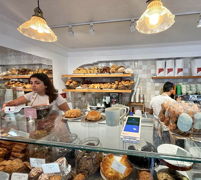 The counter where dreams come true. Staff members orchestrate a ballet of baking and brewing while customers contemplate life's most important question: one pastry or two?