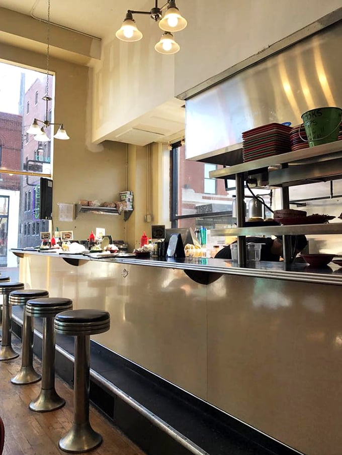 Classic diner counter seating lets you watch the breakfast magic happen while contemplating whether you'll need that second cup of coffee.