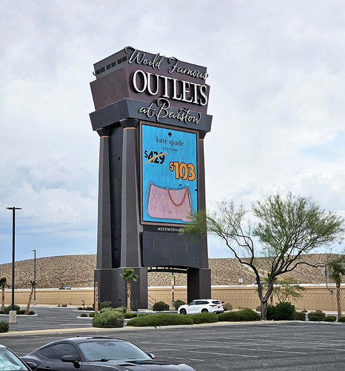 The desert lighthouse of savings. This towering sign beckons weary travelers with promises of Kate Spade at prices that won't require a second mortgage.