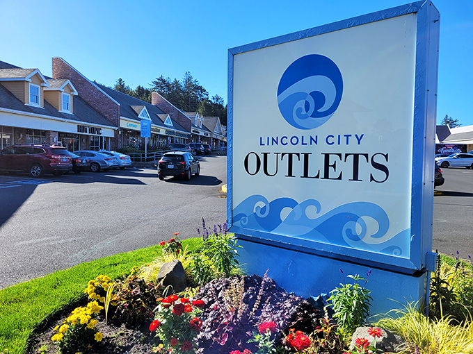 The iconic Lincoln City Outlets sign, surrounded by coastal-inspired landscaping, welcomes bargain hunters to retail paradise.