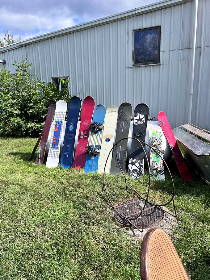 Snowboards enjoying their summer vacation, leaning casually against the shed like teenagers at a mall.