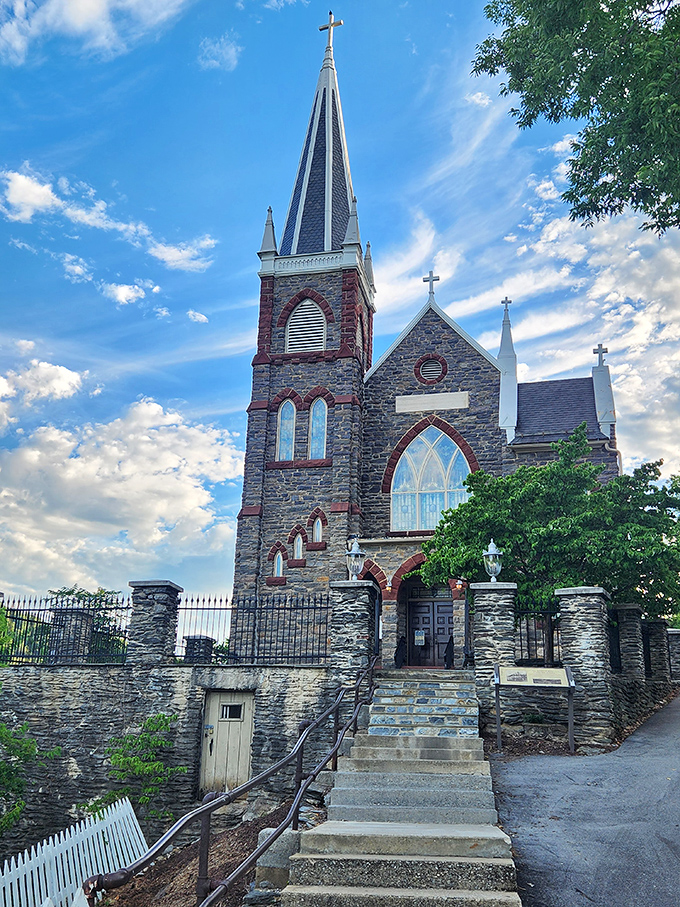 St. Peter's Church reaches skyward with its dramatic spire, a Gothic romance novel written in stone against a backdrop of heavenly clouds.