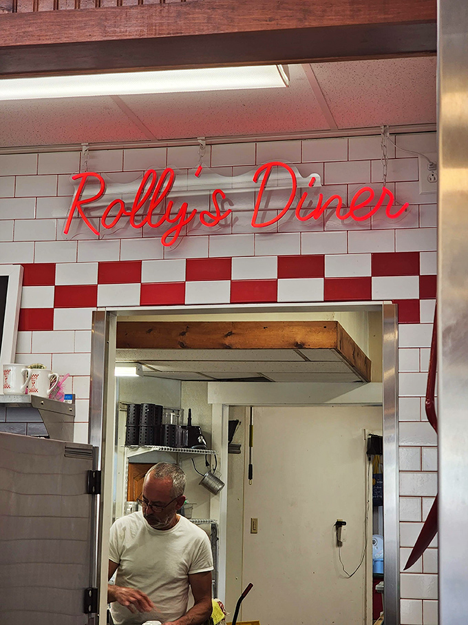 The iconic red neon sign glows against white tile&mdash;a beacon of breakfast hope in a world of rushed morning meals.