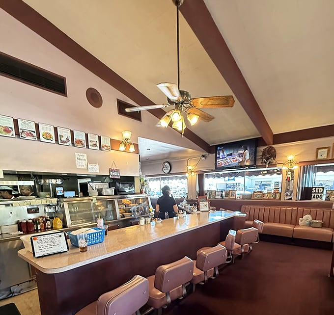 Where ceiling fans spin stories overhead while the kitchen choreography unfolds &ndash; a dance as old as the restaurant itself.