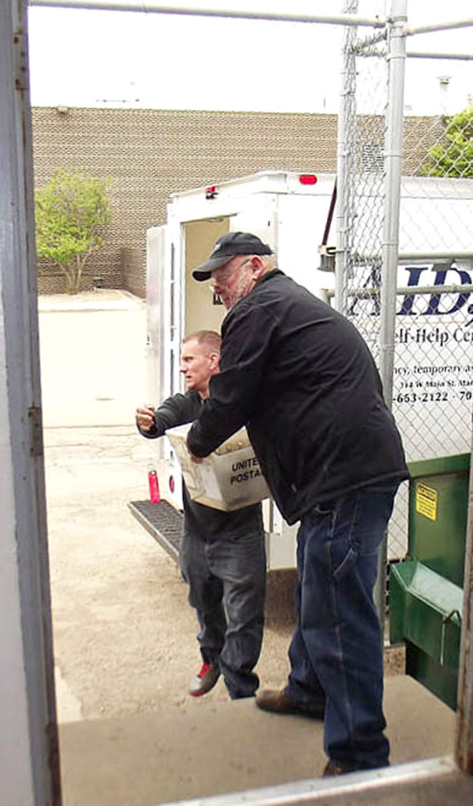 Volunteers loading supplies with the kind of teamwork that makes small towns the backbone of America itself.