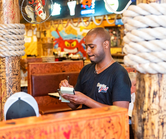 Taking orders with the focus of a ship's captain navigating stormy waters. Service with both efficiency and Southern charm.