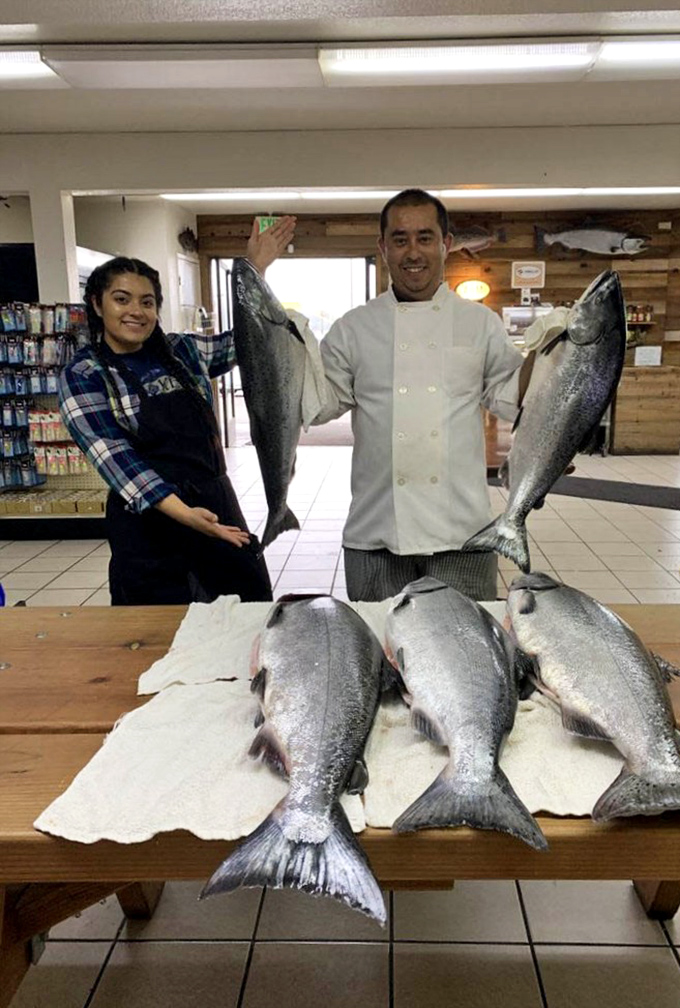 The staff proudly displaying their fresh catch—these aren't fish tales, but the real story behind why everything tastes so incredible.