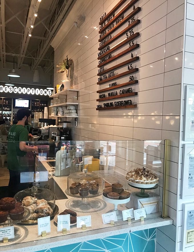 The coffee menu board promises liquid motivation in various forms. Behind the pastry case, breakfast treasures await their lucky recipients.