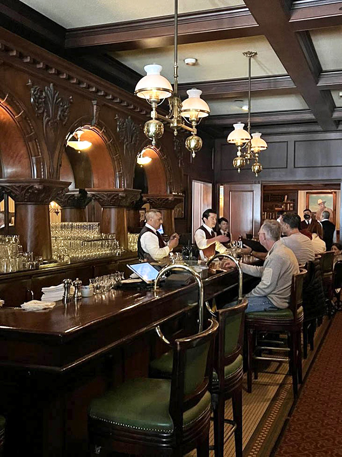 The bar isn't just where drinks are made&mdash;it's command central where vest-clad mixologists orchestrate the evening's libations with old-school precision.
