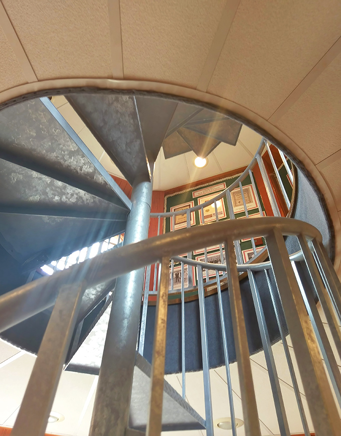 The spiral staircase winds upward like a nautical DNA strand, promising panoramic views for those willing to tackle all 76 steps.
