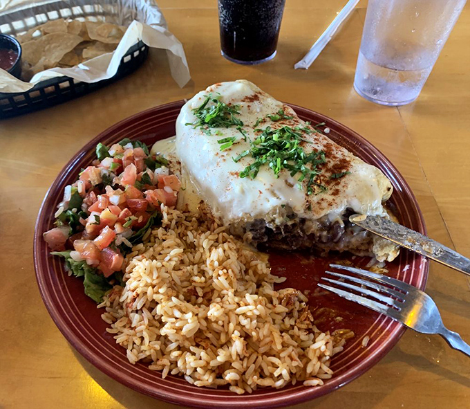 This chimichanga isn't just dinner&mdash;it's an event. The melted cheese blanket and pico de gallo garnish elevate this from meal to memory.