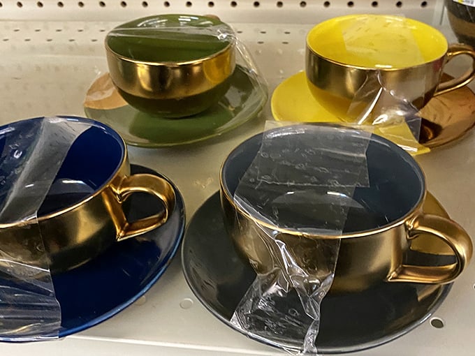 Elegant teacups with golden trim await their next sophisticated afternoon gathering, proving secondhand doesn't mean second-best.