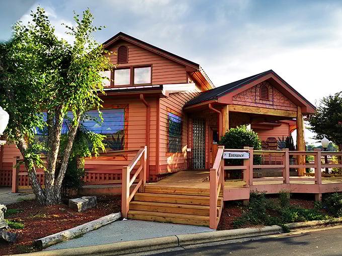 This vibrant orange building with its welcoming porch practically shouts "come on in" to passersby seeking authentic local experiences.