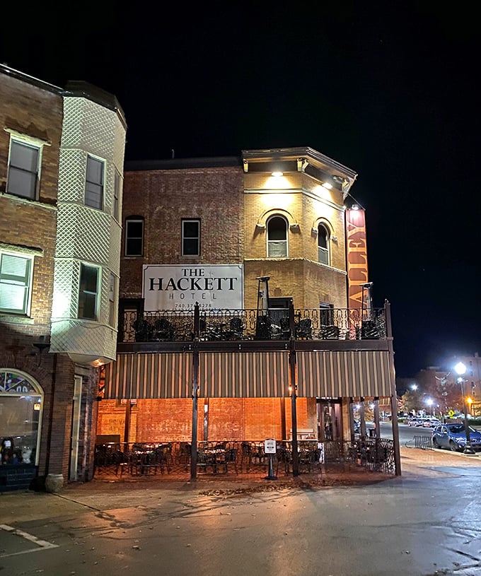 Night transforms The Hackett Hotel into a warm beacon of hospitality. Its illuminated fa&ccedil;ade hints at evening conversations over reasonably priced cocktails.