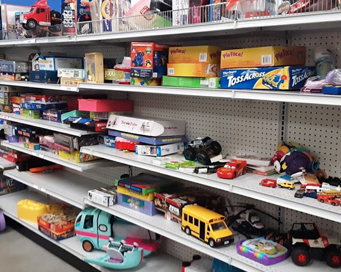 Toy story in progress—yesterday's playthings awaiting new adventures. That yellow school bus might have decades of imaginary routes left to run.