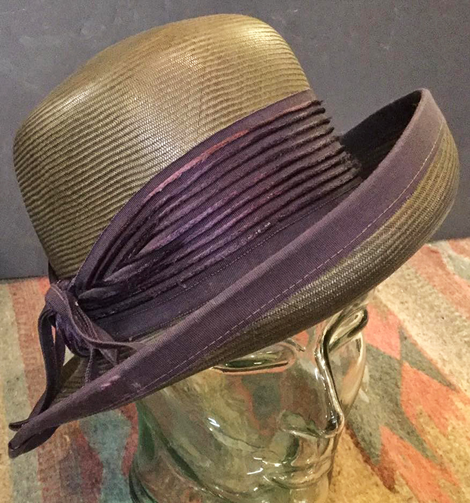 Hats weren't just fashion statements but identity markers. This olive and purple number once topped someone who knew exactly who they were.