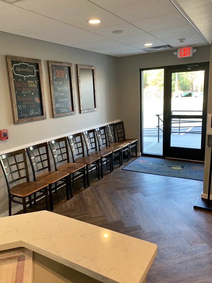The waiting area where anticipation builds and the chalkboard specials tempt you to order more than you planned. Strategic seating for maximum menu-browsing.