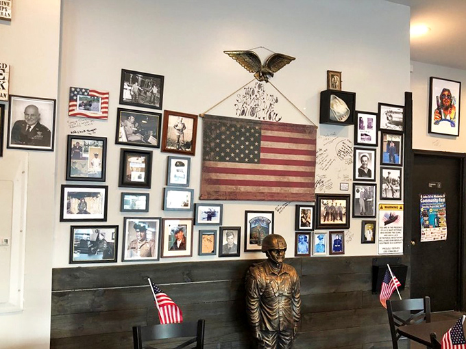 Patriotic wall d&eacute;cor featuring an American flag, eagle, and military photos honors service members in this community-focused restaurant space.