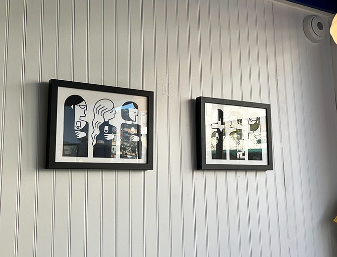 Minimalist art adorns white-paneled walls, offering just enough visual interest without distracting from the main event happening on your plate.