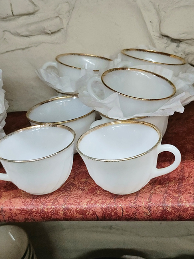 Milk glass teacups with gold rims&mdash;because your grandmother was right, everything does taste better from a proper cup.