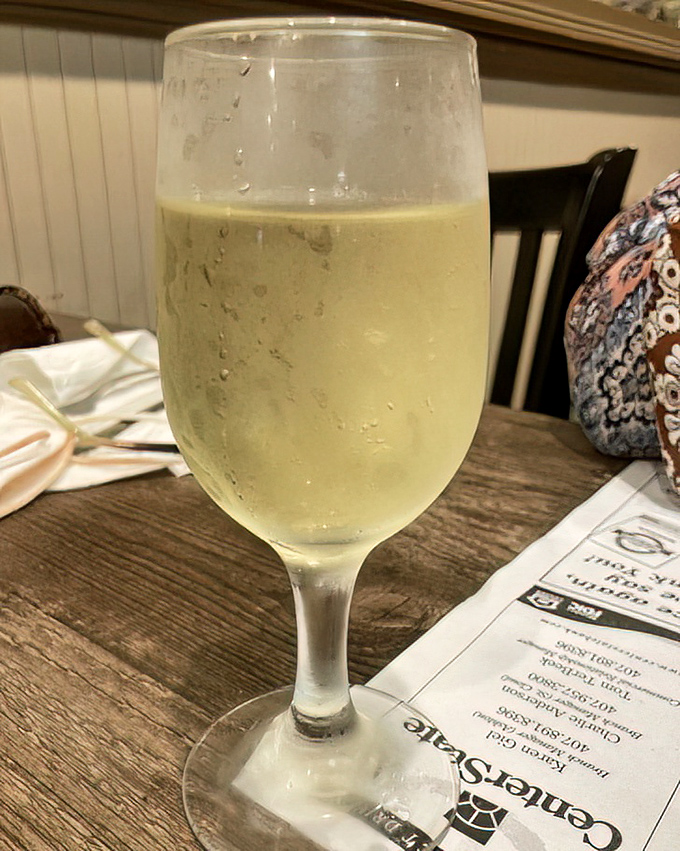 A glass of chilled white wine waiting patiently to complement your seafood feast&mdash;because sometimes sweet tea needs a sophisticated friend.