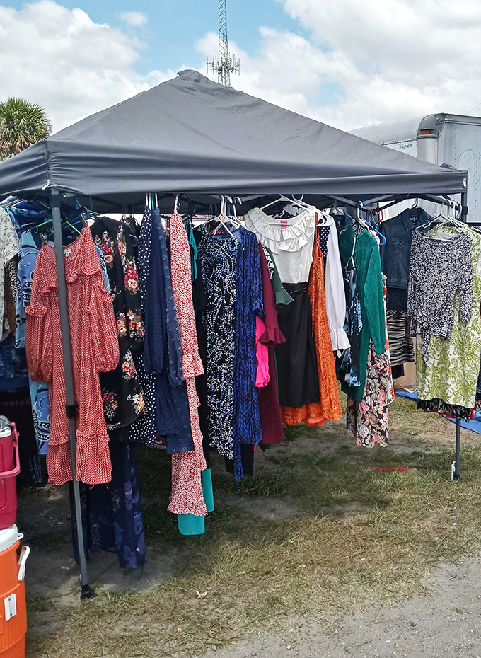 Women's dresses hanging like a rainbow decided to open a boutique under a tent in Central Florida's sunshine.