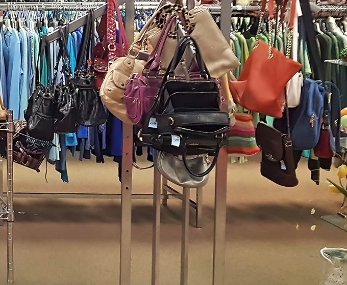 Handbag heaven! Designer dreams at down-to-earth prices hang like fashionable fruit ready for picking.