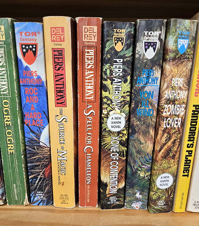 Well-loved spines of Piers Anthony's Xanth novels stand like old friends at a reunion, ready to transport readers to pun-filled magical realms.