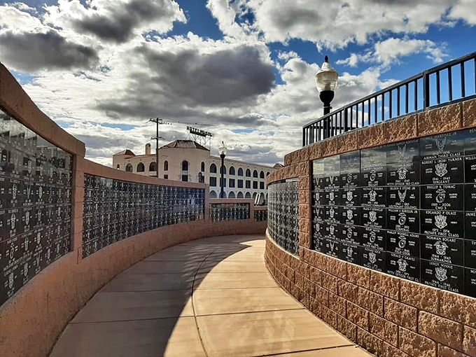 The Armed Forces Park memorial wall curves through desert landscape, honoring service members under the same big Arizona sky they protected.