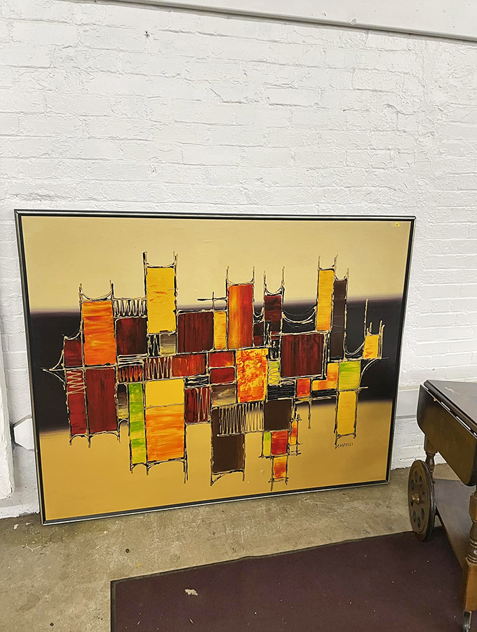 Abstract art that perfectly captures that mid-century modern vibe without the gallery price tag. Someone's redecorating loss is your living room's gain.