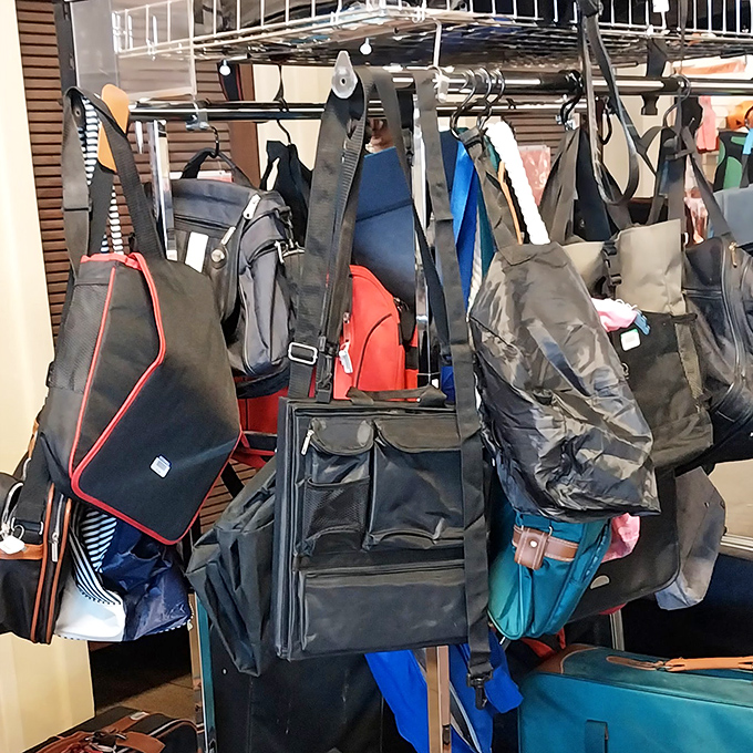 Handbags dangle like leather fruit, each one carrying invisible stories from previous adventures.