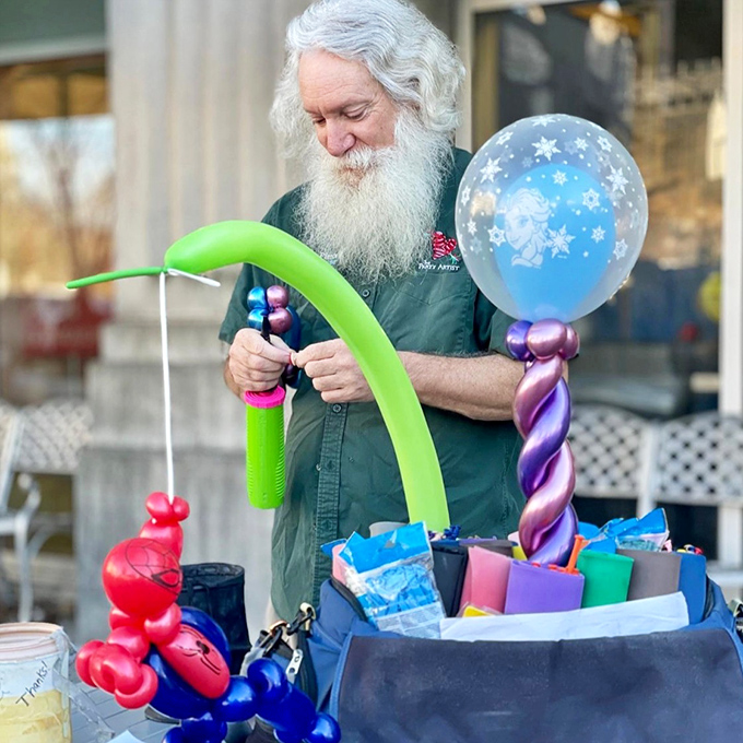 The market's unofficial mayor spreads joy one balloon creation at a time. His nimble fingers craft whimsical memories while vegetables wait patiently nearby.