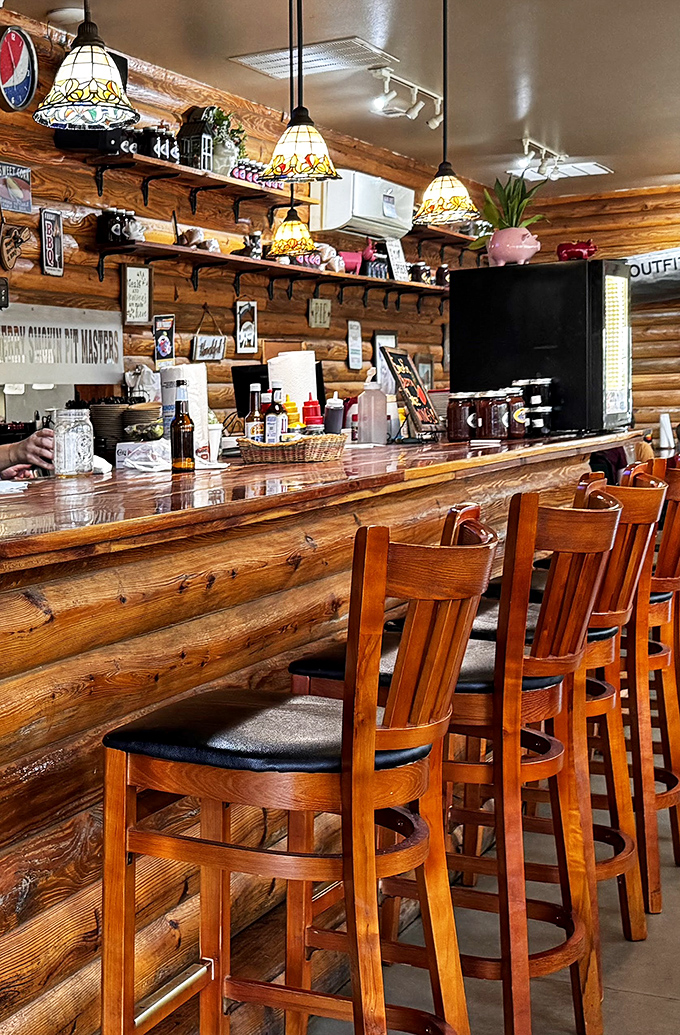 The bar isn't just serving drinks &ndash; it's a front-row seat to barbecue theater, with stained glass lamps adding a touch of unexpected elegance.